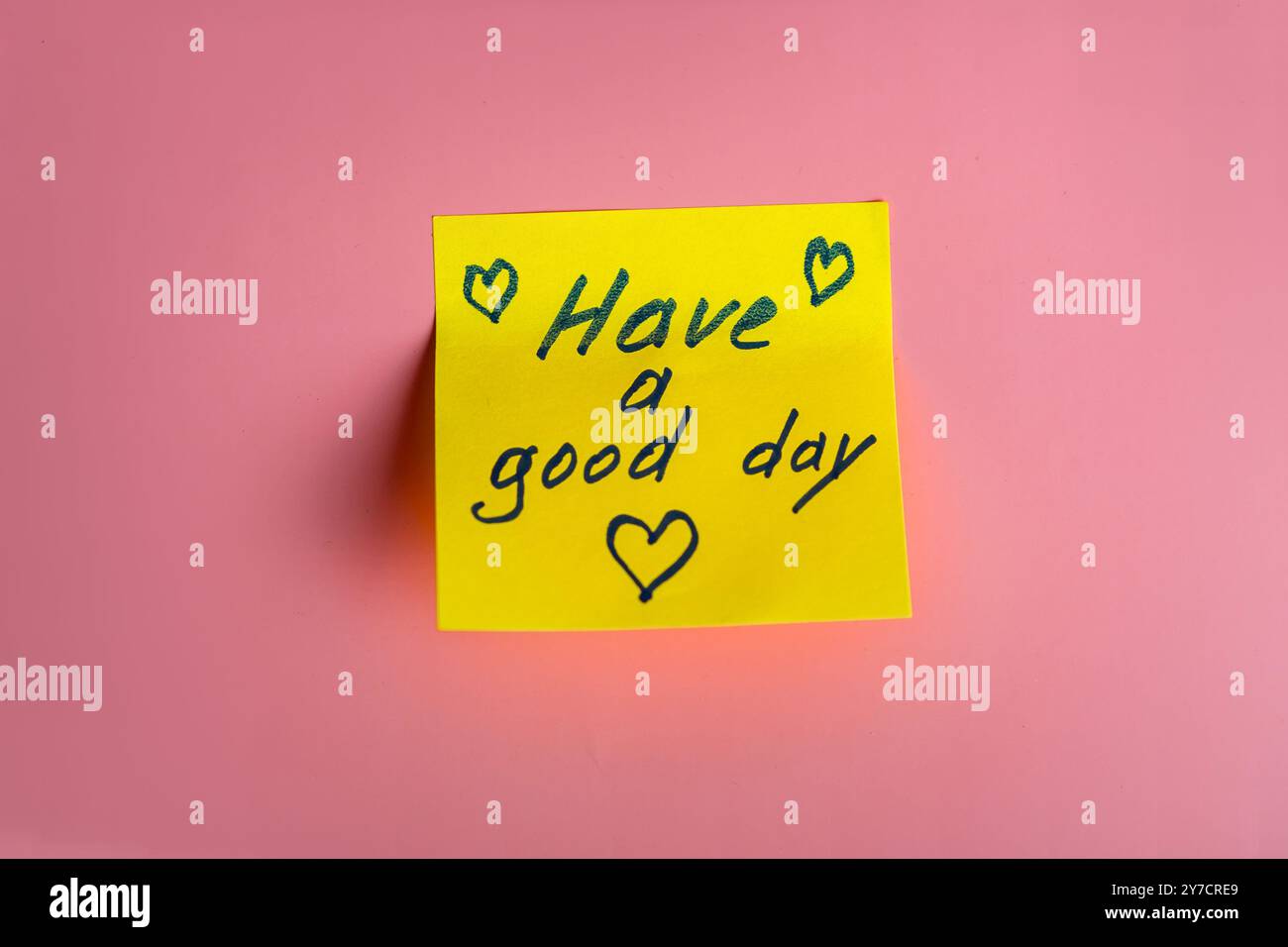 Bright yellow sticky note with uplifting message on pink background ...