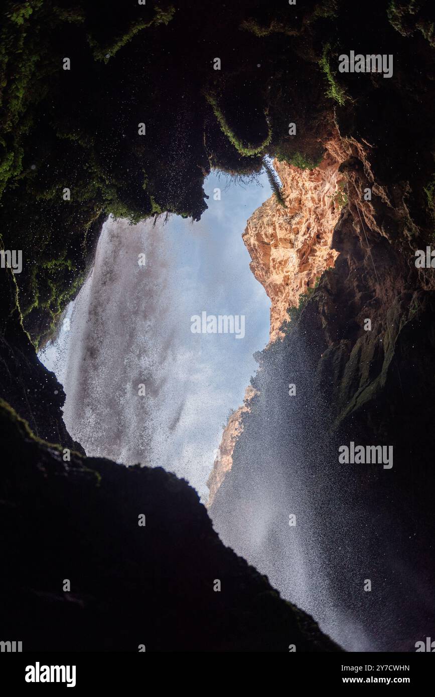 Peer through the cascading water of Horse Tail Waterfall at Monasterio ...