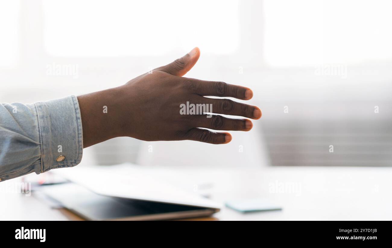 Hand of african american man extended for handshake Stock Photo - Alamy