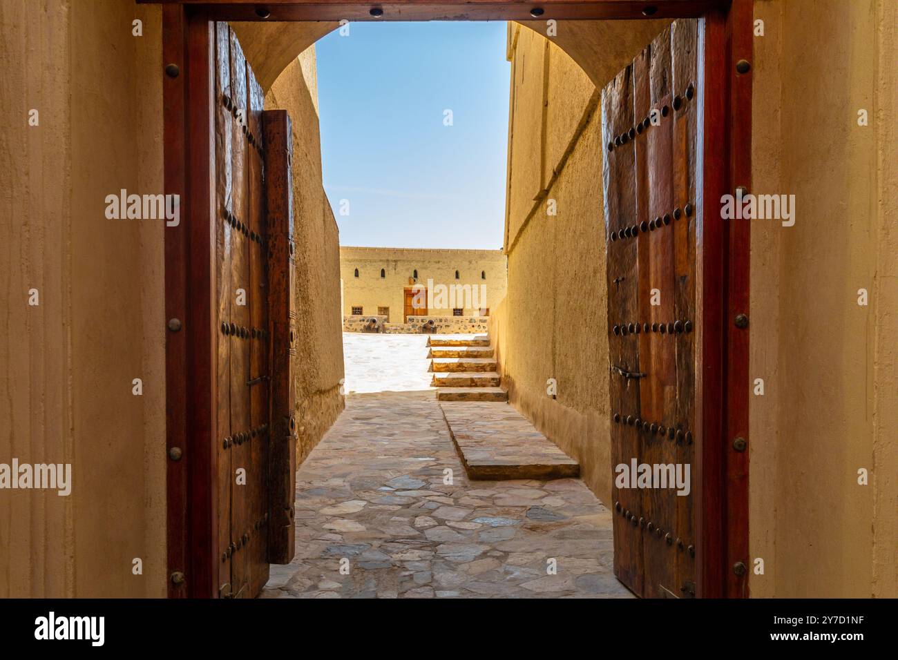 View through the decorated wooden doors to arabic citadel fortress ...