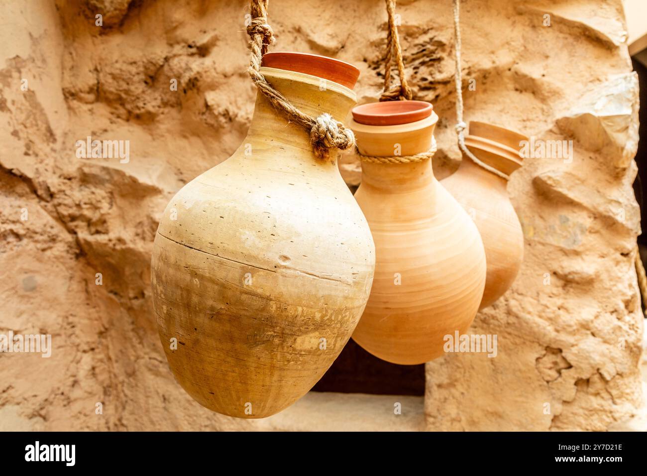 Water pottery jugs hanged in arabic citadel fortress inner yard, Nizwa ...