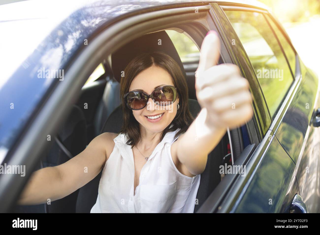 A smart looking middle-aged adult woman wearing sunglasses put her hand ...