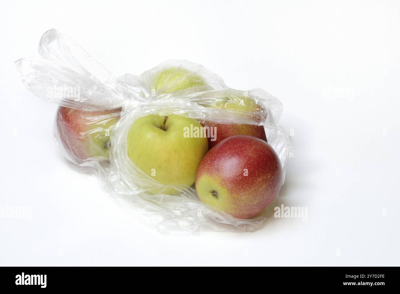 Apple in plastic bag, packaging Stock Photo - Alamy