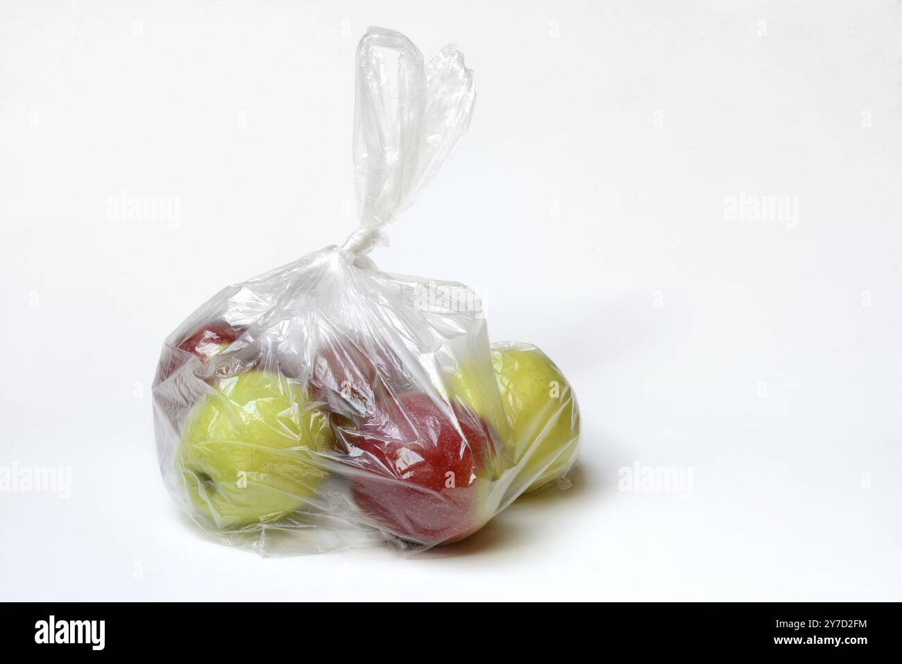 Apple in plastic bag, packaging Stock Photo - Alamy