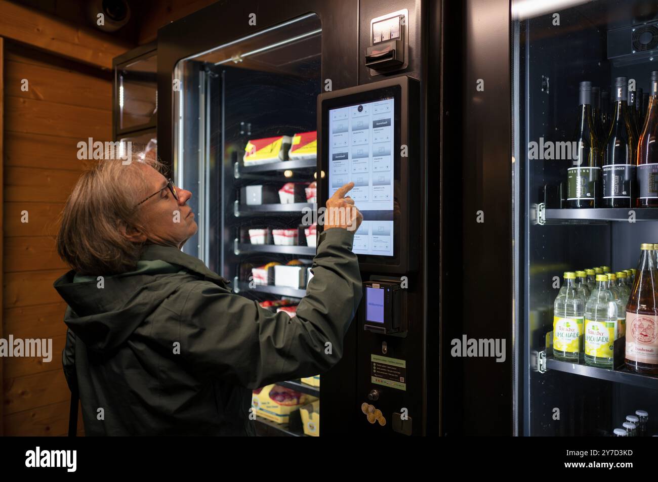 Elderly woman buying groceries at vending machine, display, food ...