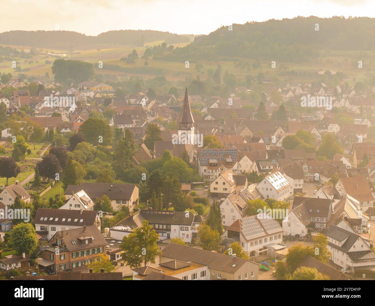 A picturesque village with numerous buildings and a large church in the ...