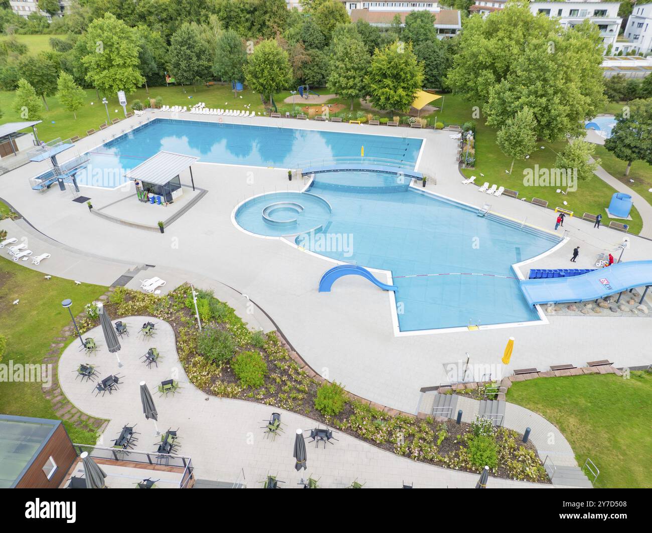 Aerial view of an outdoor pool with swimming pool, deckchairs and ...
