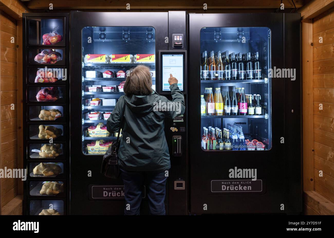 Elderly woman buying groceries at vending machine, display, food ...