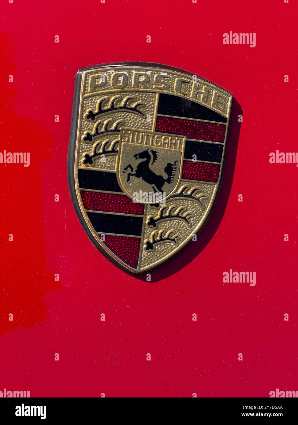 Historic old Porsche crest logo on red painted bonnet of vintage ...