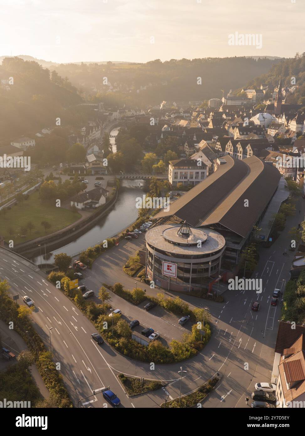 Aerial view of a town with a river, buildings and streets surrounded by ...