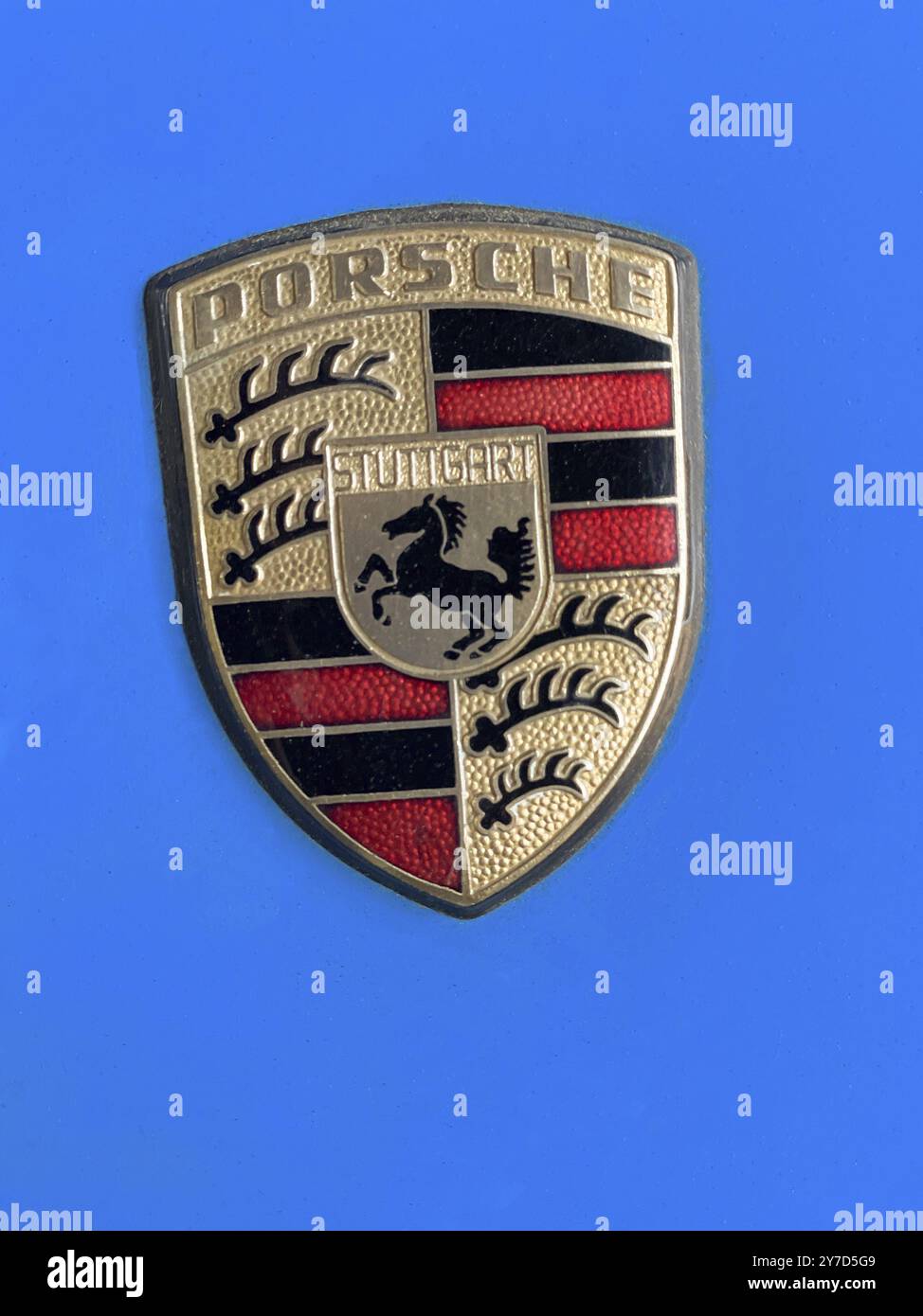Historic old Porsche crest logo on blue painted bonnet of vintage ...