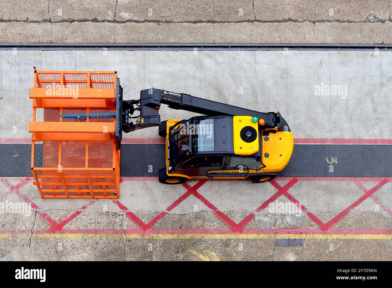 Aerial view of a JCB 30D HL Teletruck returning an empty cage used to ...
