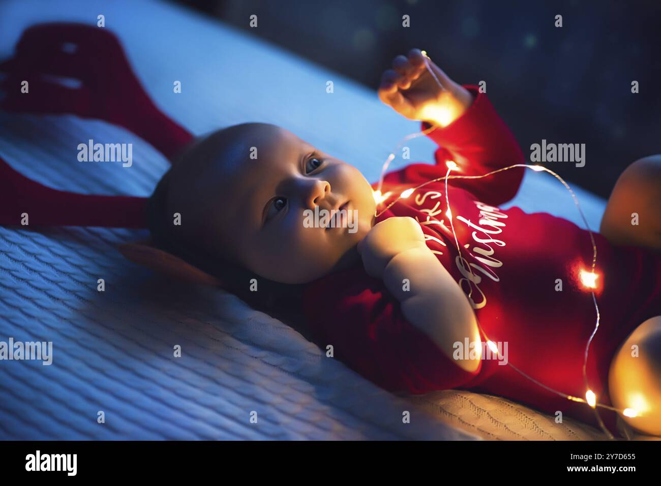 Baby girl wearing Santa's crawling with very determined facial ...