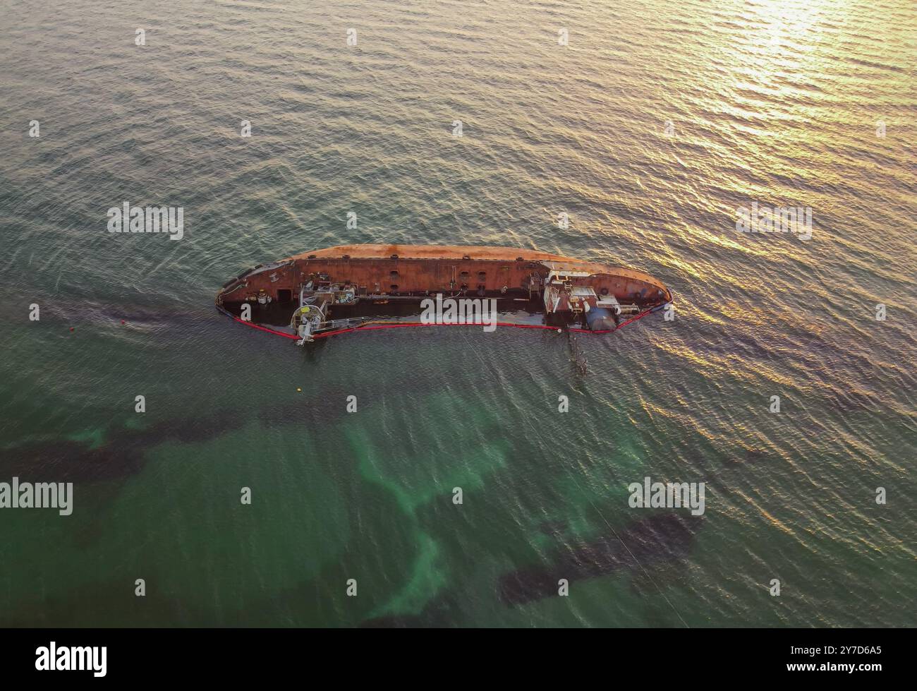 The old rusty ship was stranded by a storm. Oil spill from a tanker ...