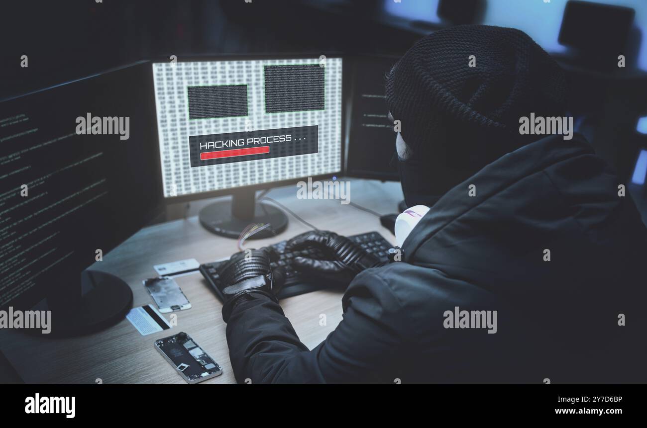 Shot from the Back to Hooded Hacker Breaking into Corporate Data Servers from His Underground ...