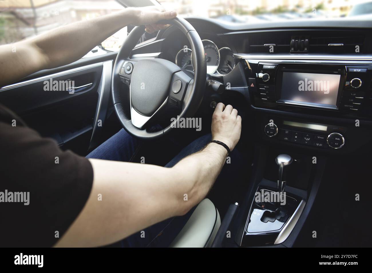 Male arms holding leathern rudder of car Stock Photo - Alamy
