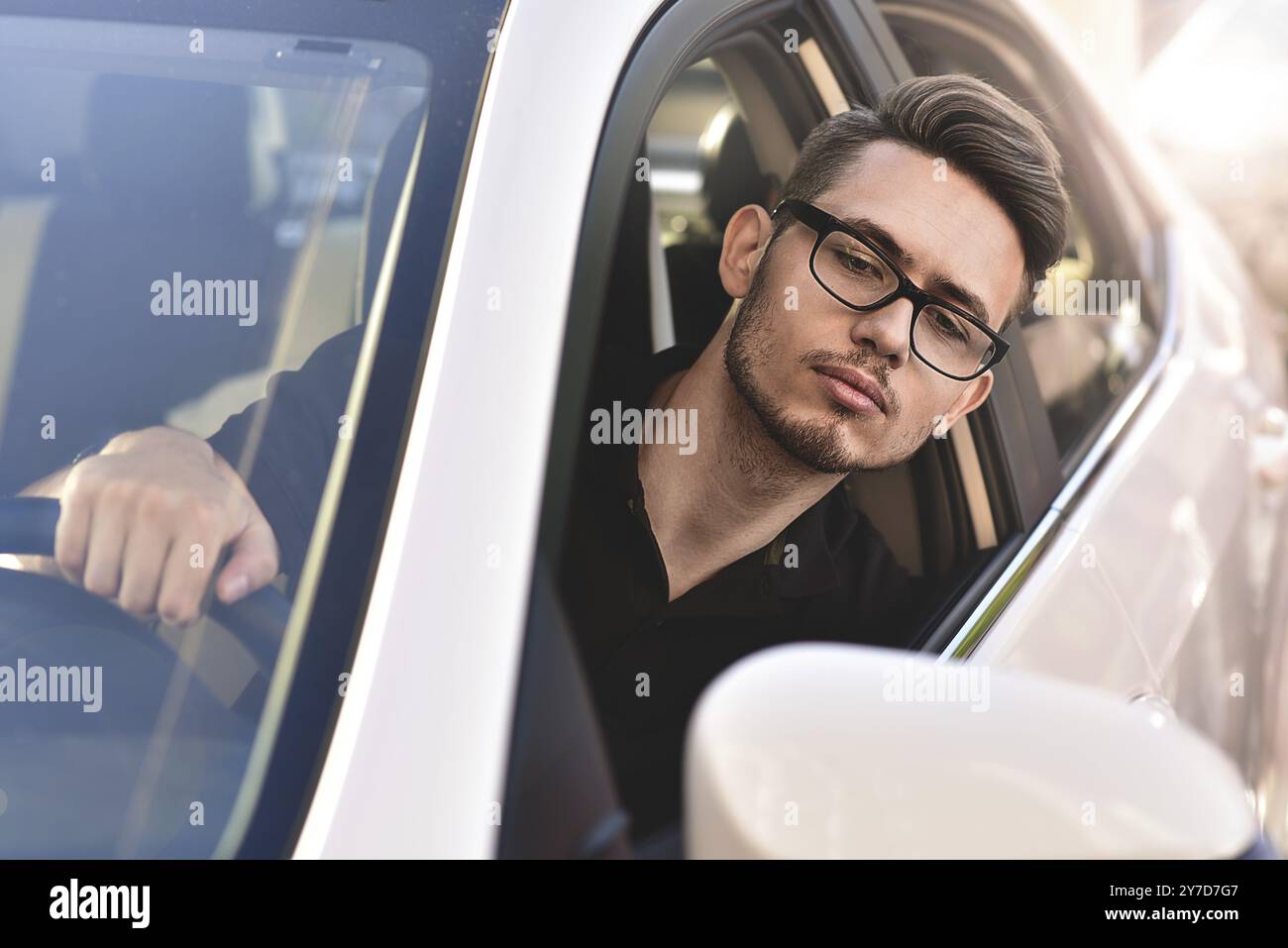 Portrait of a handsome guy driving his car Stock Photo - Alamy