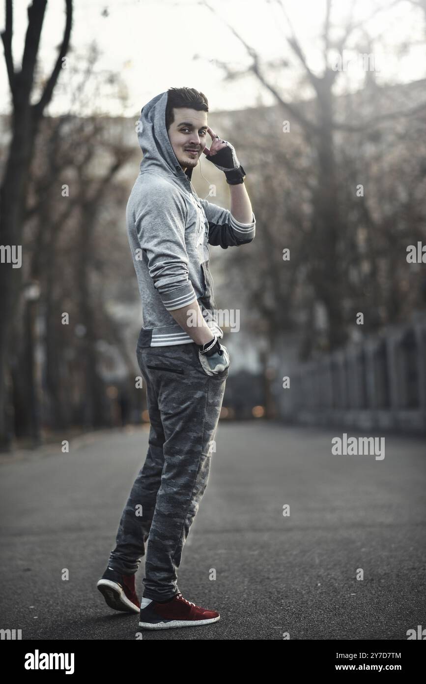 Sporty young man working out at early morning with background sunrise ...