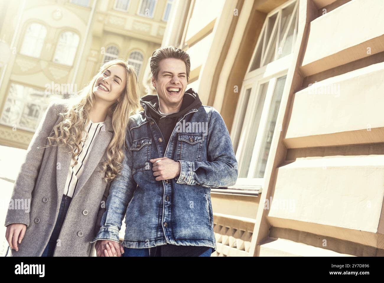 Young laughing couple enjoying sunny mood and having fun Stock Photo ...