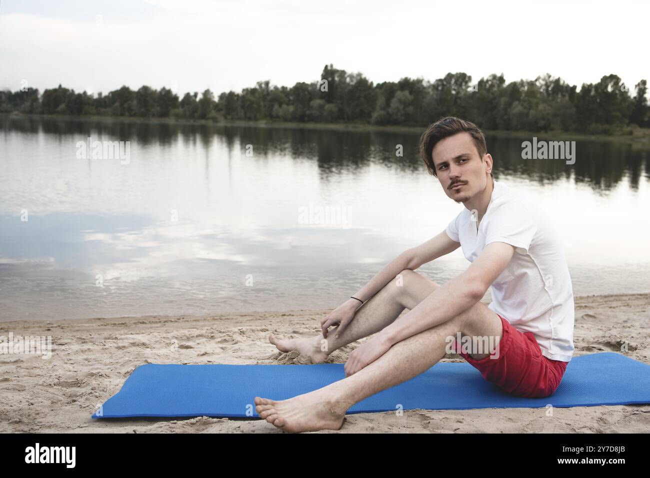 Male relaxing on beach looks hi-res stock photography and images - Alamy