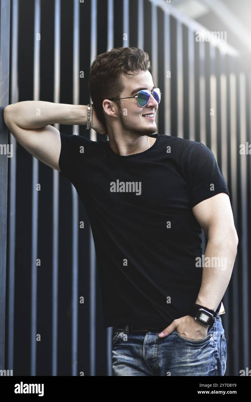 Young stylish and confident happy handsome guy model in t-shirt ...