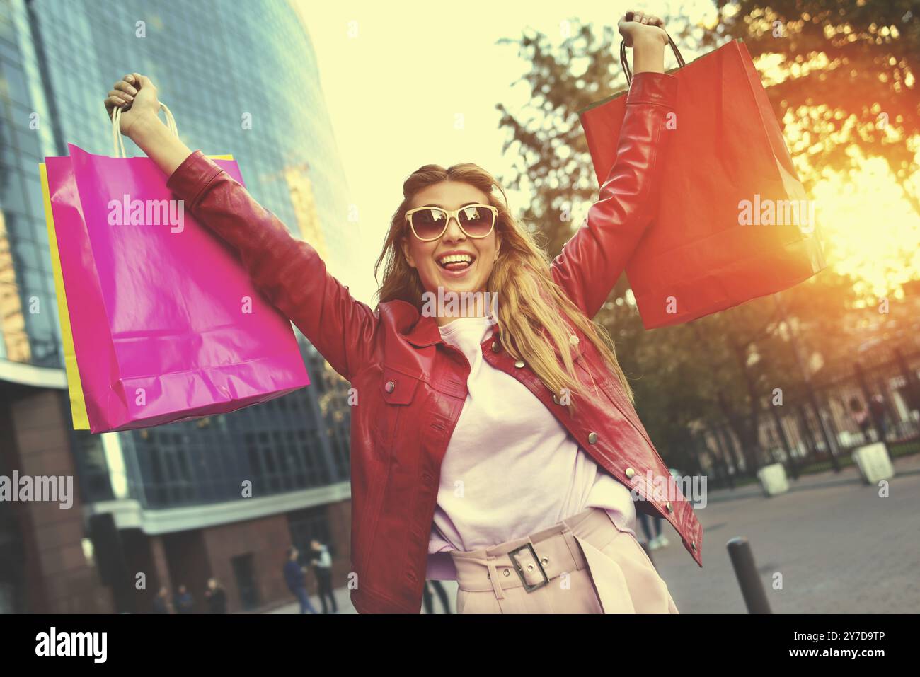 Shopping woman walking outside at street holding shopping bags. Shopper ...