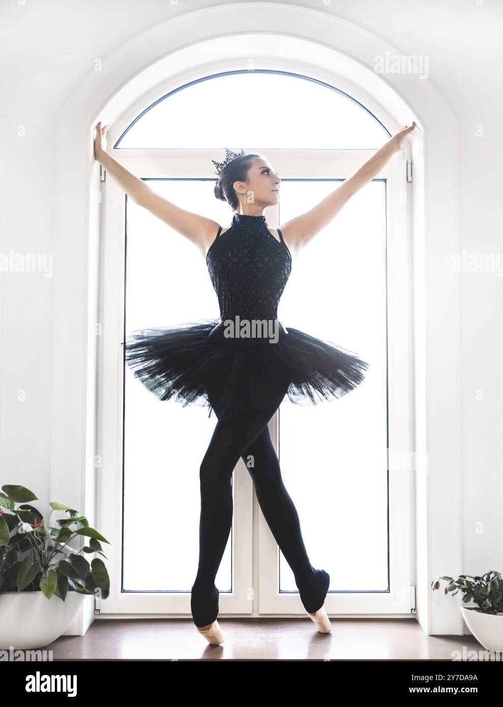 Young ballet dancer practicing before performance in black tutu ...