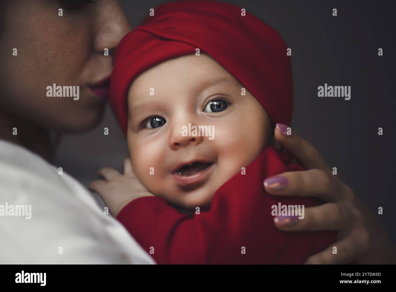 Loving Mother Cuddling Newborn Baby daughter Over Shoulder Stock Photo ...