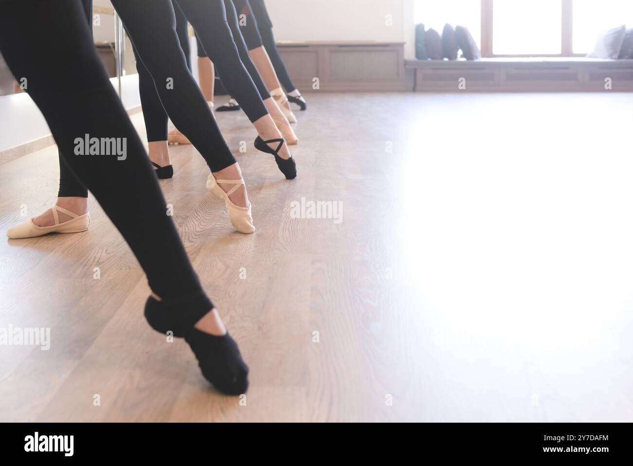 Low section of The graceful legs of ballet dancers standing in a row on ...