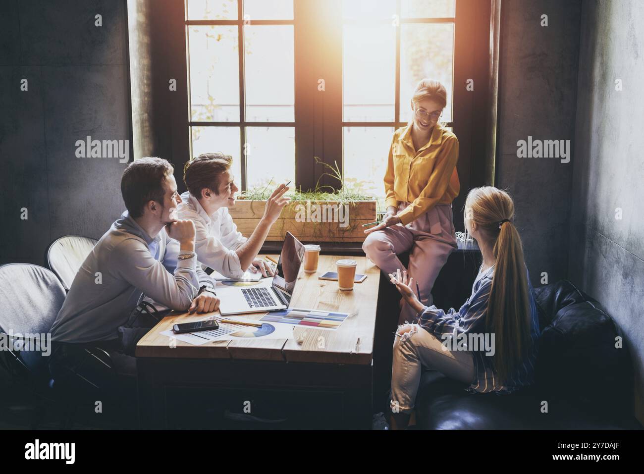 Group of colleagues having meeting in boardroom while working on big ...