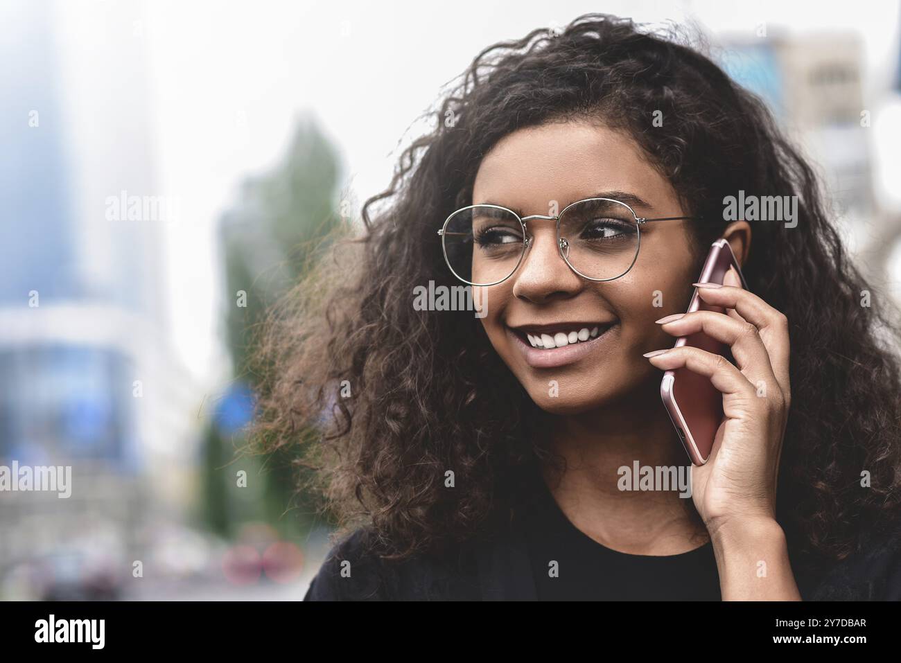 Happy beautiful woman walking and writing or reading sms messages Stock ...