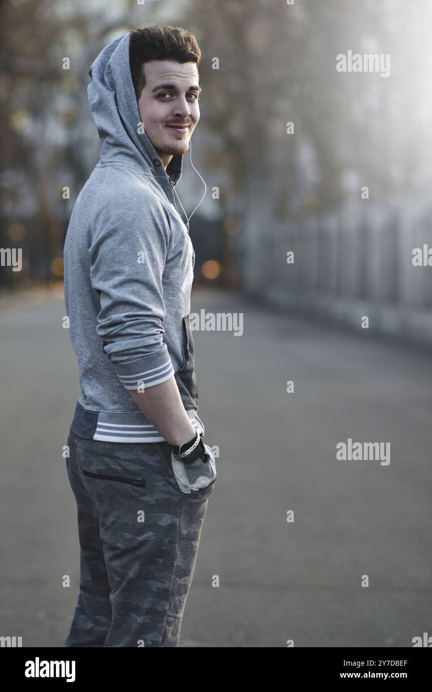 Sporty young man working out at early morning with background sunrise ...