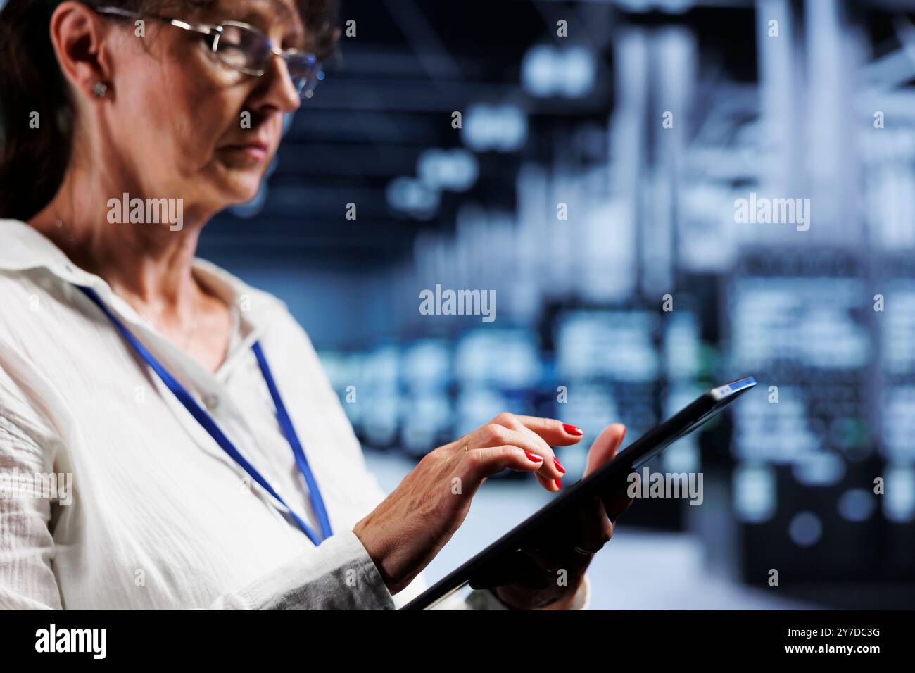 Aged IT professional using tablet, ensuring valuable data remains ...