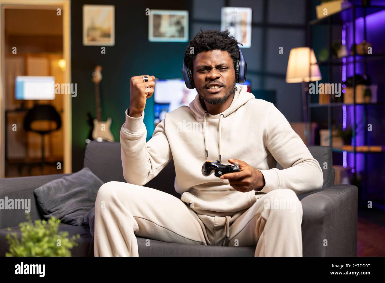 Cheerful gamer feeling excited after finally defeating all enemies and ...