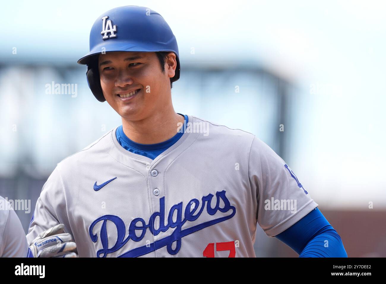Los Angeles Dodgers' Shohei Ohtani smiles after reaching first base on ...