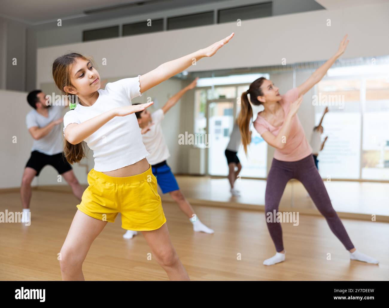 Girl exercising during family dance class Stock Photo - Alamy