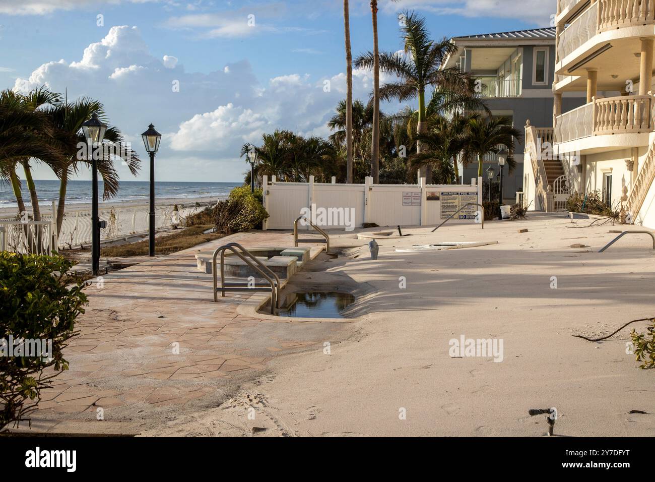 A condominium swimming pool filled with sand from Hurricane Helene ...