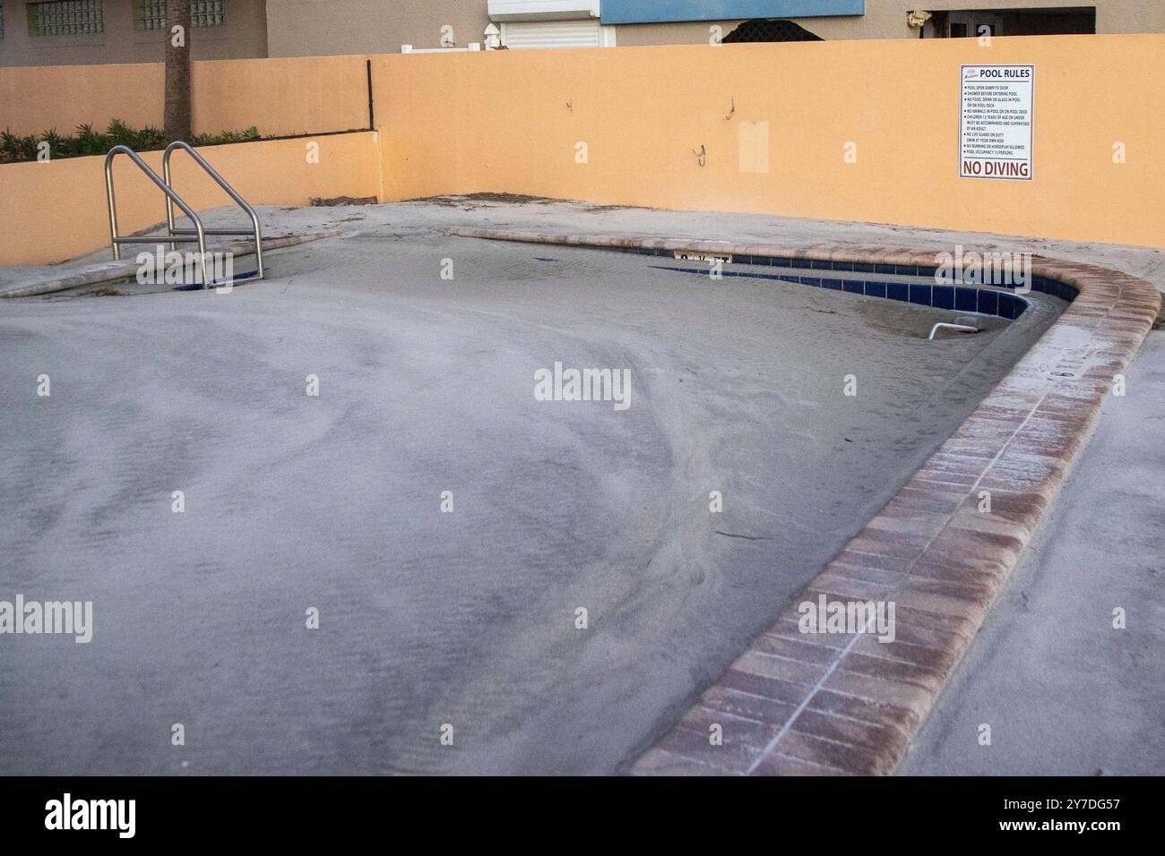 A swimming pool is completely filled with sand after storm surge from ...
