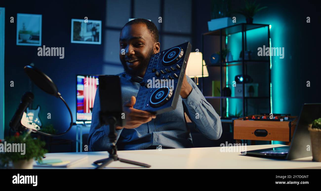 Artist filming DJ mixing tutorial in apartment studio, showing examples ...