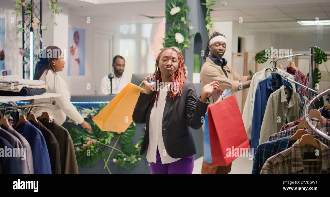 African american couple having fun in fashion boutique, doing dance ...