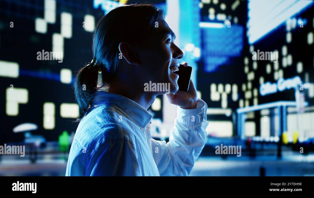 Asian man wandering around city avenues during nighttime, talking over ...