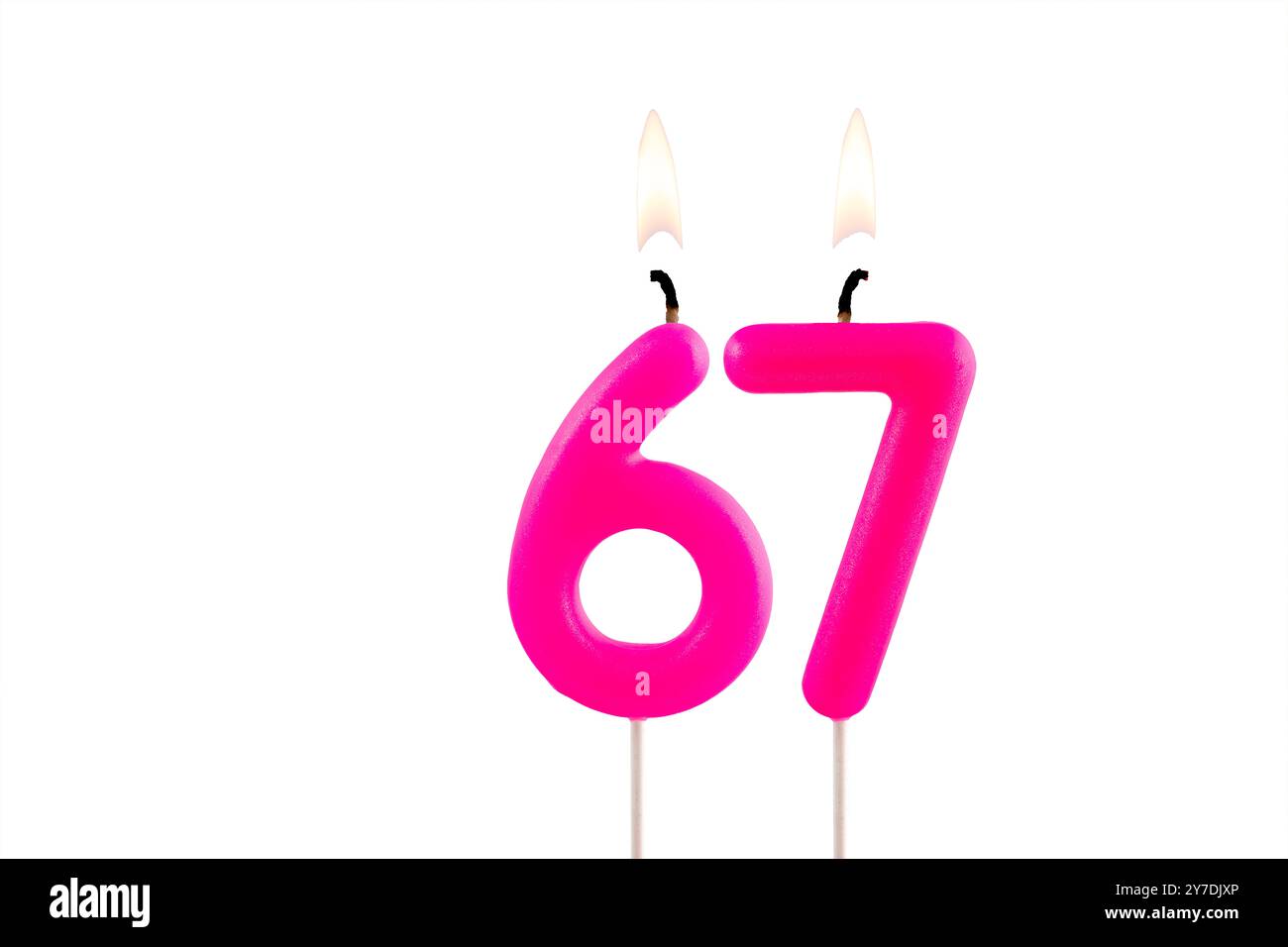 Pink number 67 birthday candle on white background Stock Photo - Alamy