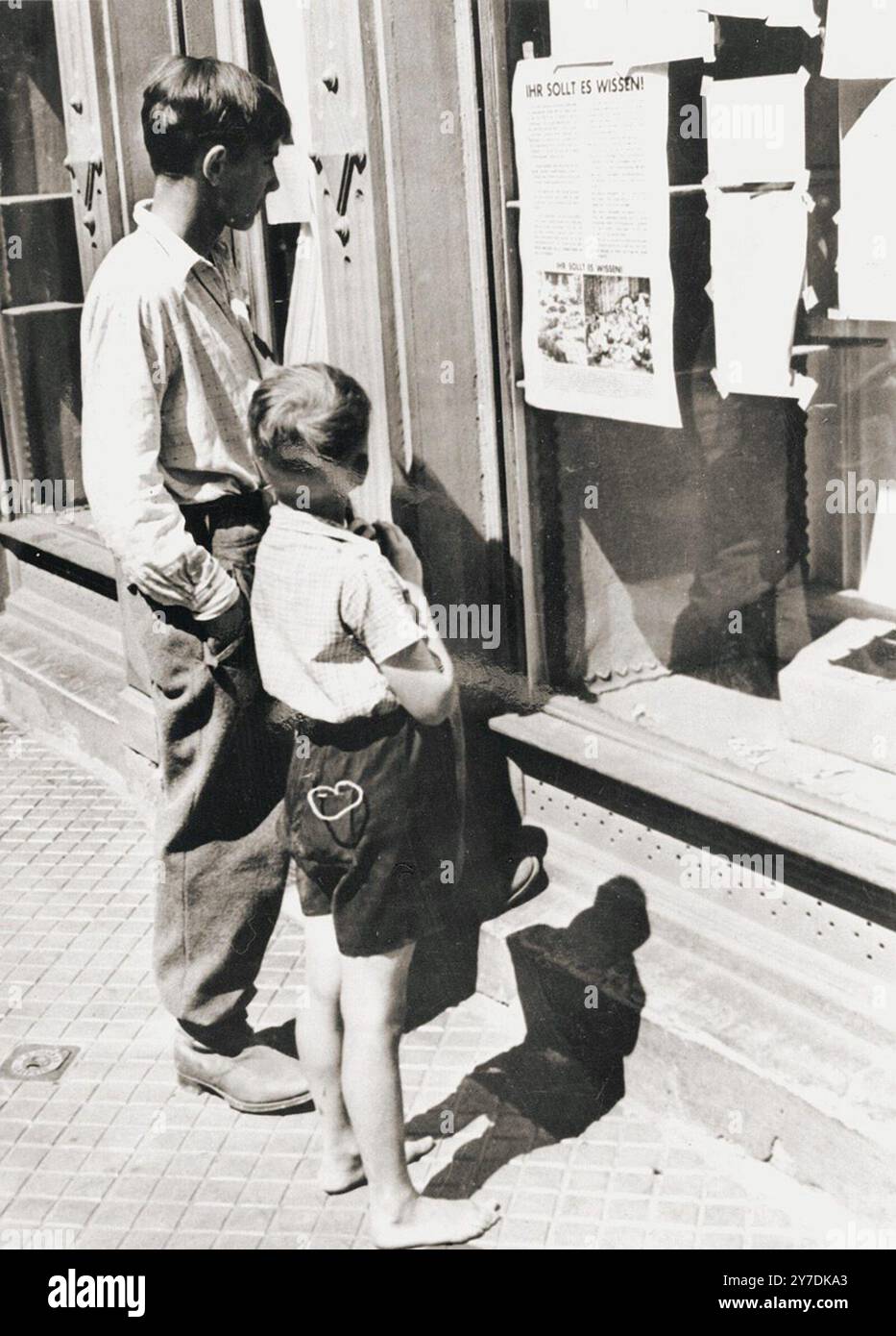 Two German boys rom Possneck read a poster put up by the U.S. Army ...