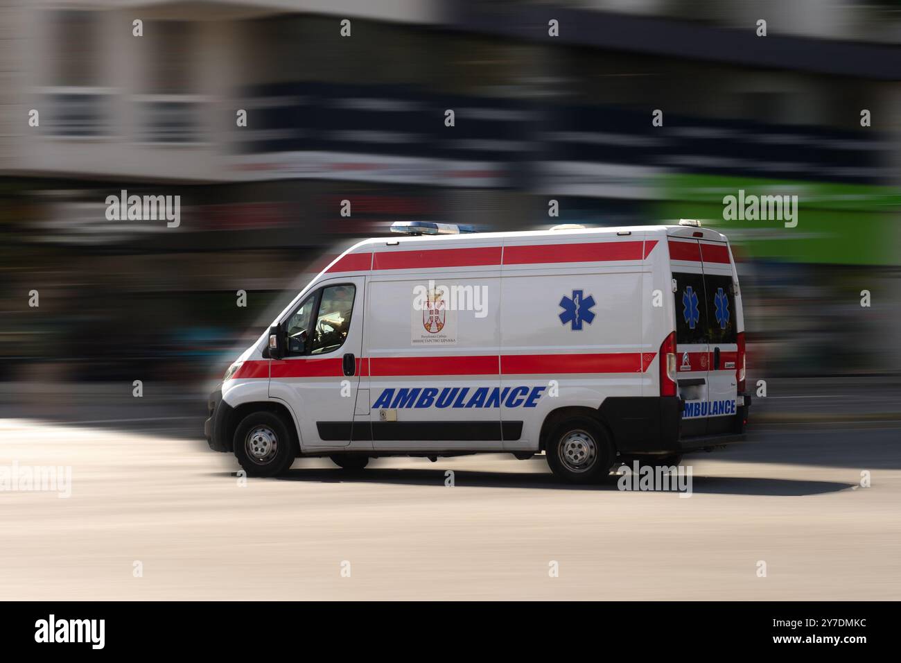 Speedy ambulance racing against time, with a dynamic, blurred city ...