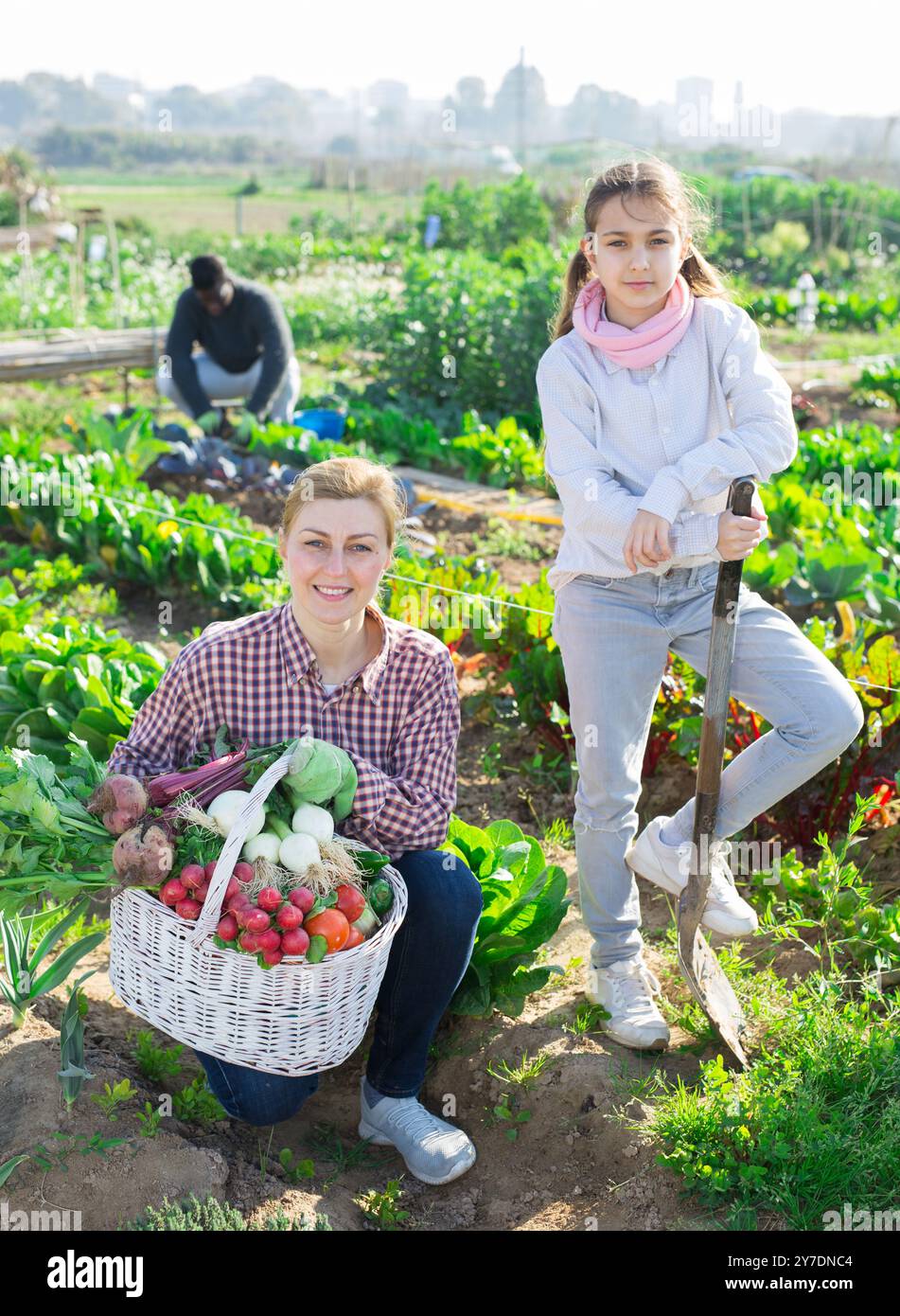 Portrait of a young woman with a teenage girl in the vegetable garden ...