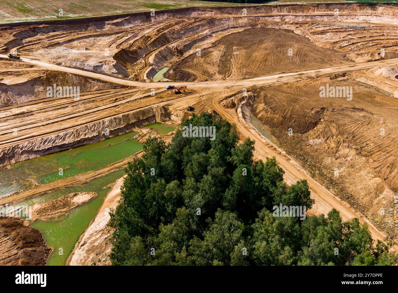 Aerial view of a preserved forest area in the middle of a huge sand ...
