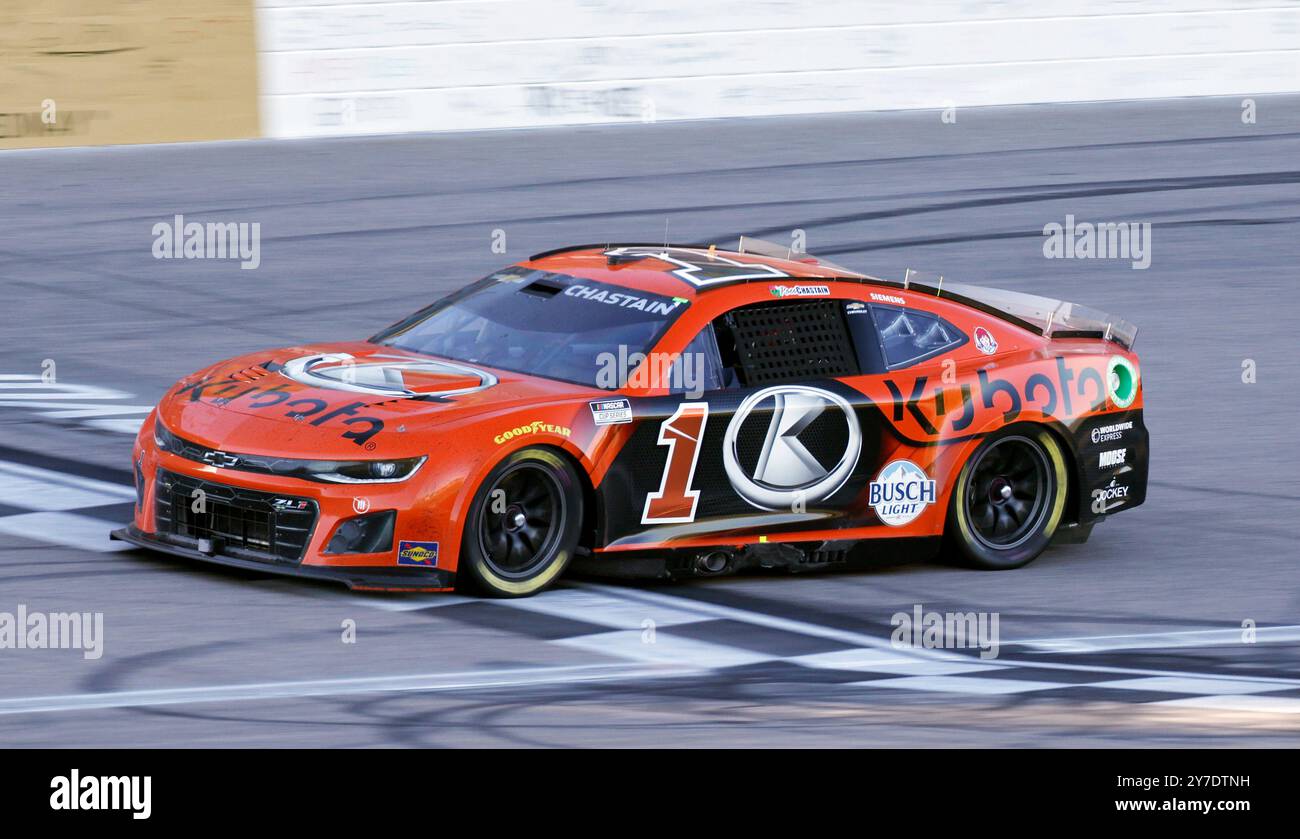 Ross Chastain crosses the finish line to win a NASCAR Cup Series auto race at Kansas Speedway in ...