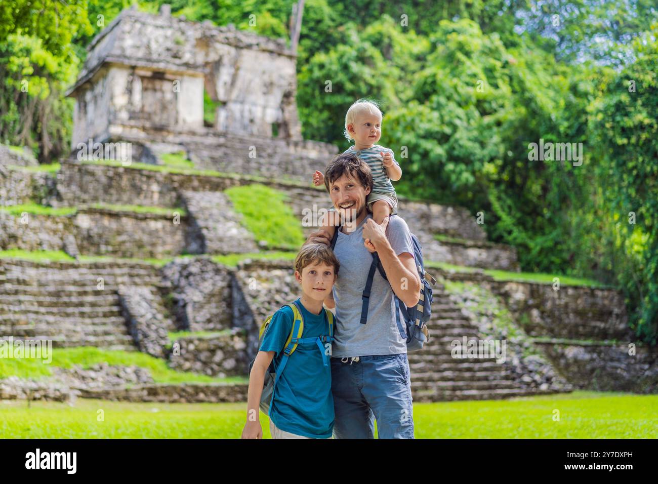 Father with his toddler and teenage sons exploring the ancient pyramids ...