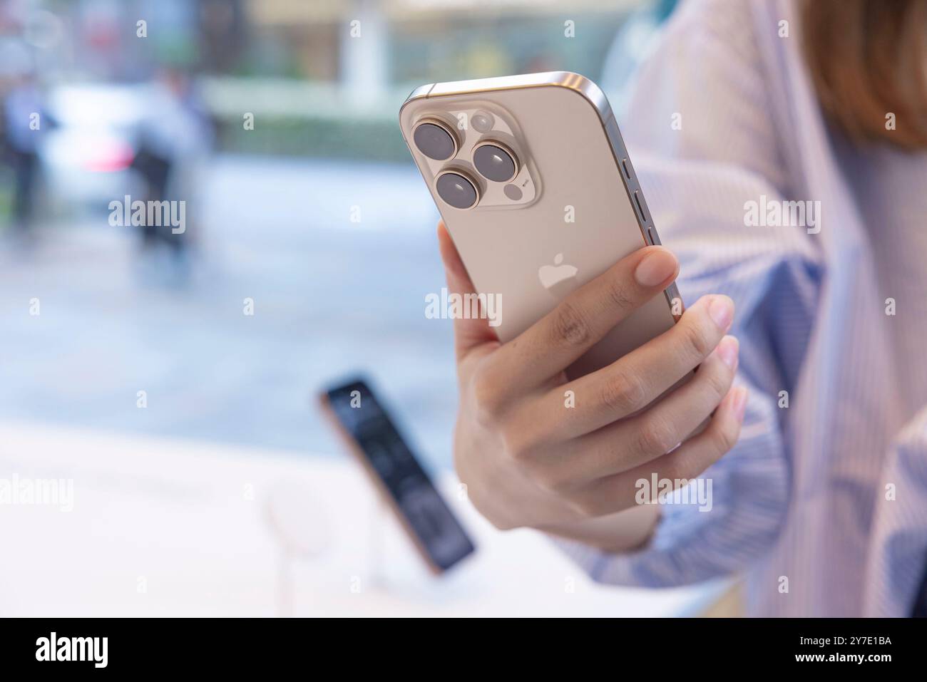 A customer holds the new Apple iPhone 16 Pro in her hand inside the ...