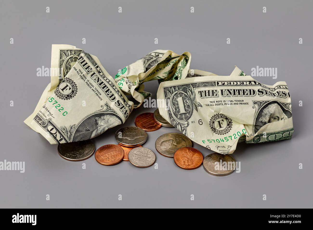 Crumpled cash money and coins. Spare change, tipping, and financial ...